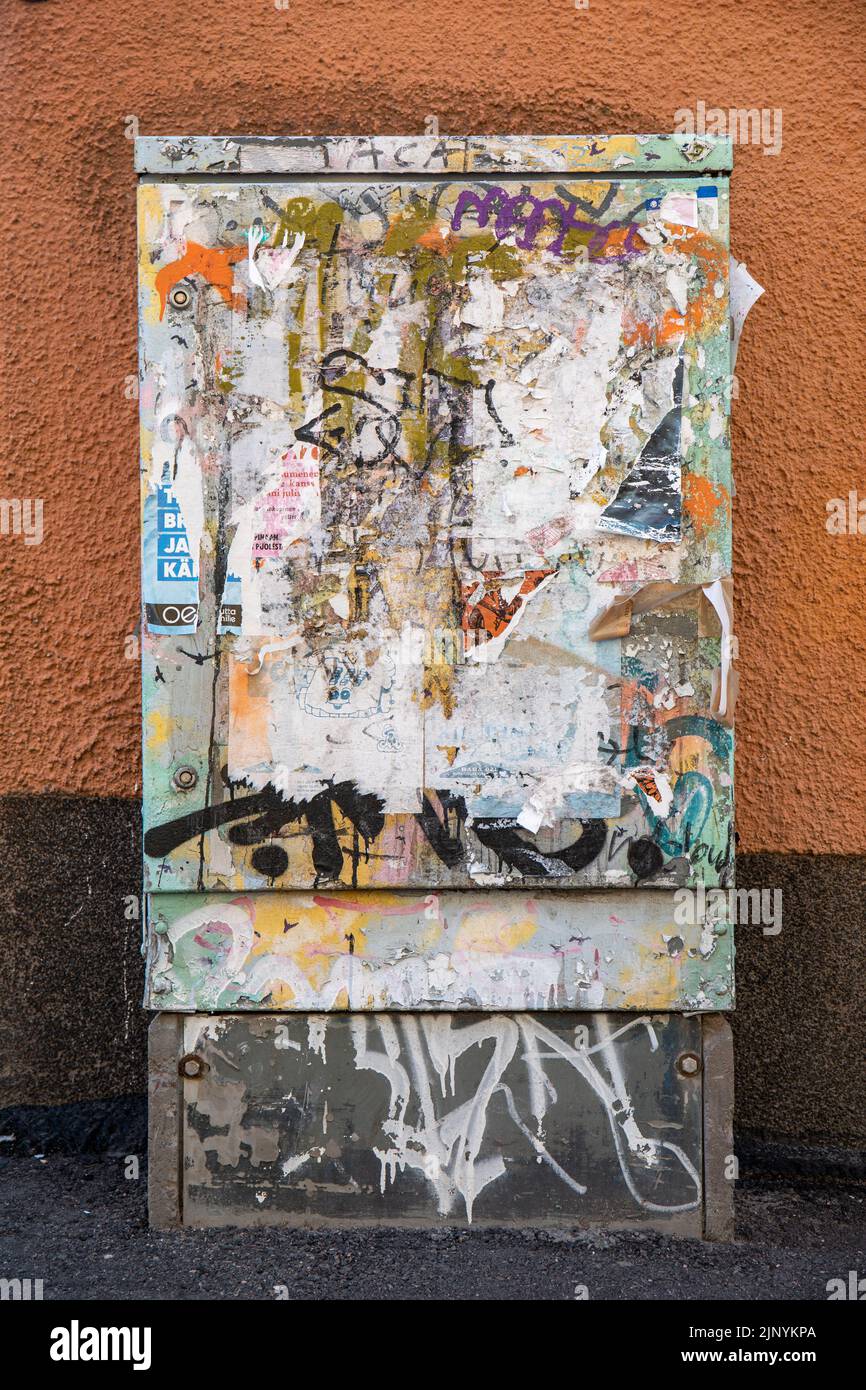 Street cabinet covered in tags and torn posters in Kallio district of ...