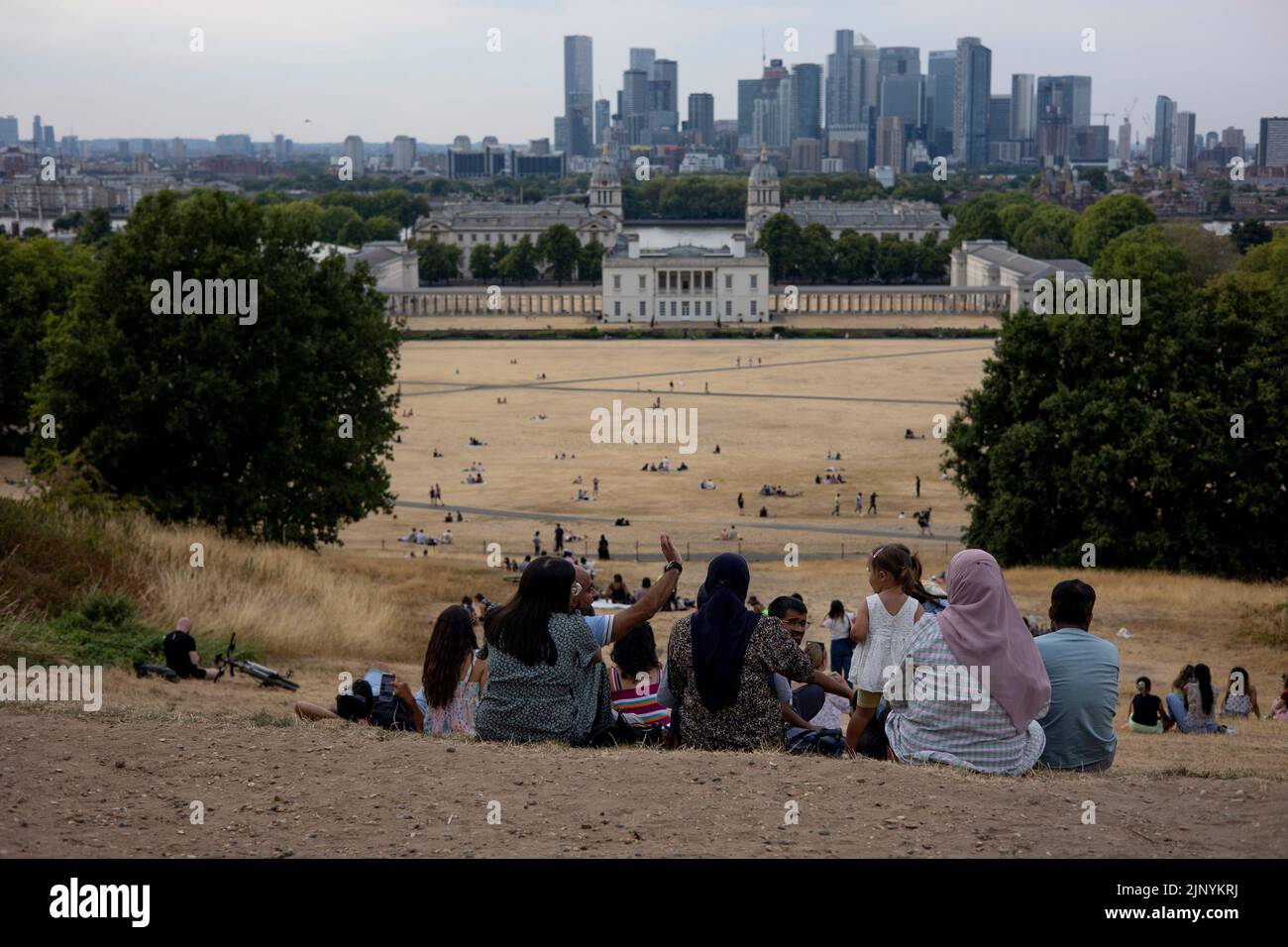 A family seen relaxing on the dry grass in Greenwich Park. 8 out of 14 ...