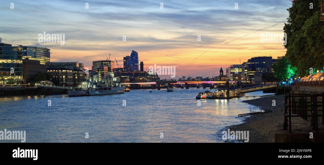 London Skyline illuminated at night - looking up the river Thames ...