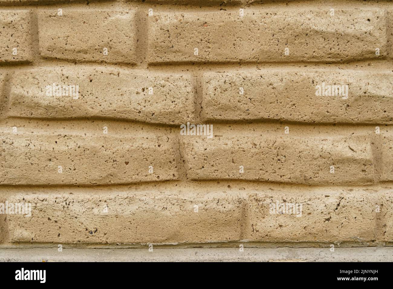 Cream background texture with concrete uneven color of beige bricks ...