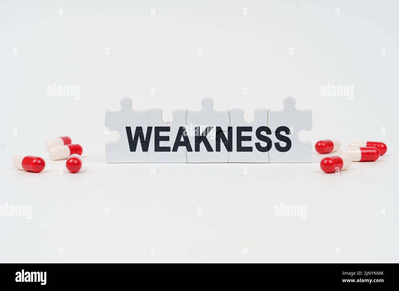 Medical concept. On a white surface are tablets and puzzles with the ...