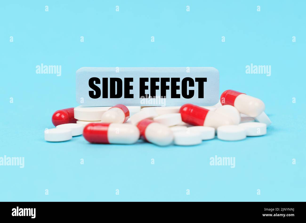 Medical concept. On the blue surface of the pills, capsules and a plate ...