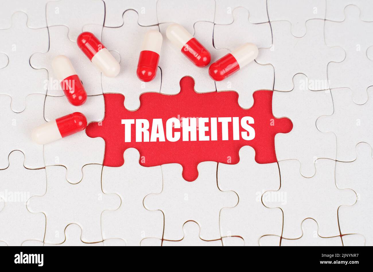 Medical concept. There are pills on the white puzzles, in the middle ...