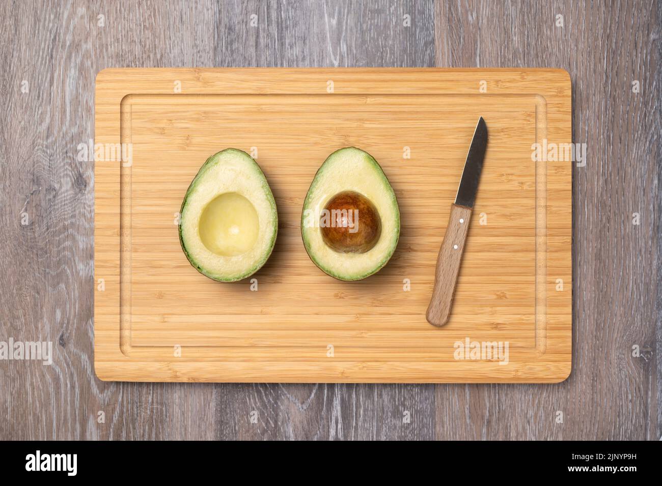 ripe haas avocados on a kitchen cutting board, top view, diet food ...