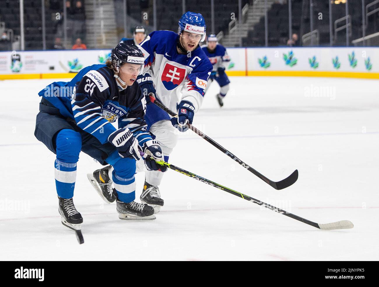 Finland's Ville Koivunen (24) is chased by Slovakia's Rayen Petrovicky ...
