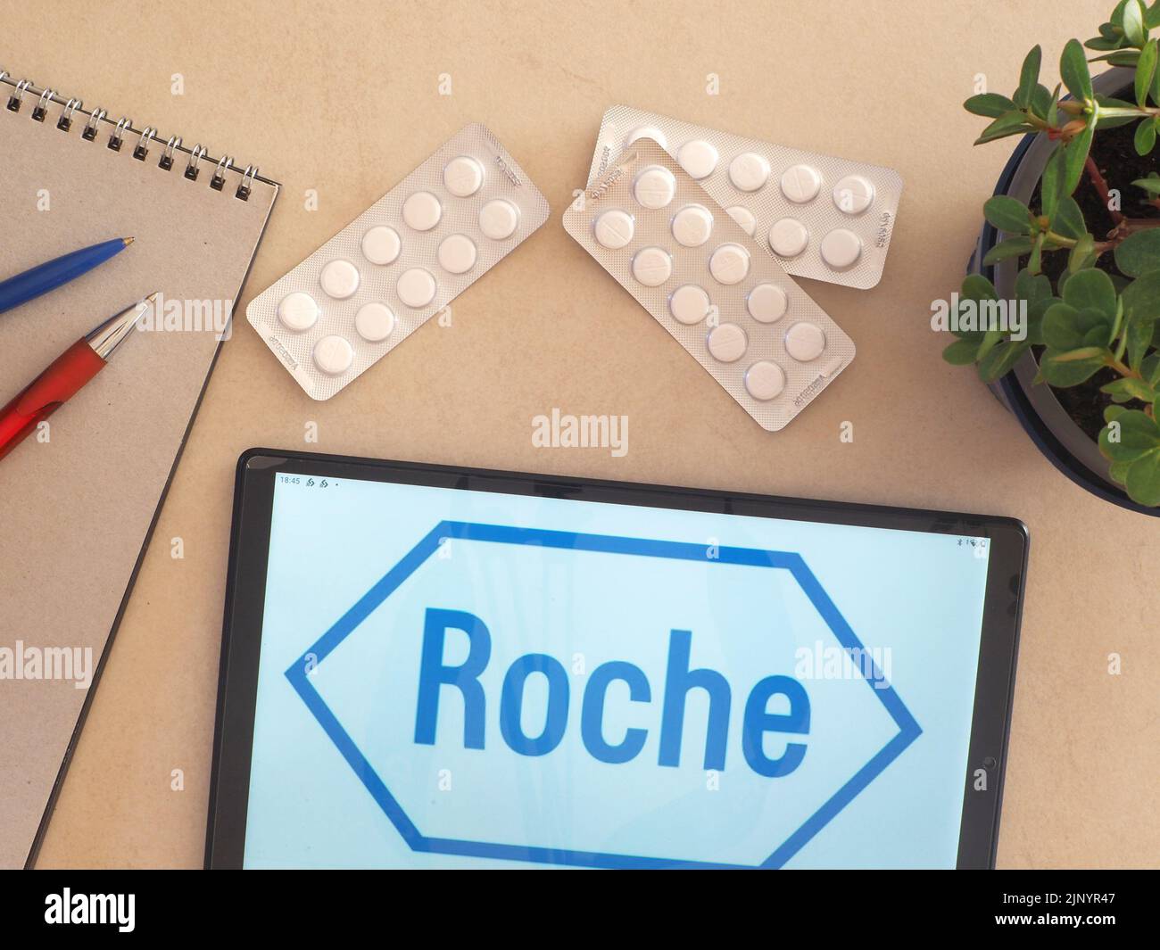 In this photo illustration, Roche Group logo seen displayed on a tablet ...