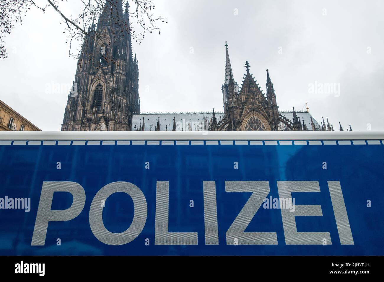 View past a German police car sign at the Cologne cathedral (Kölner Dom ...