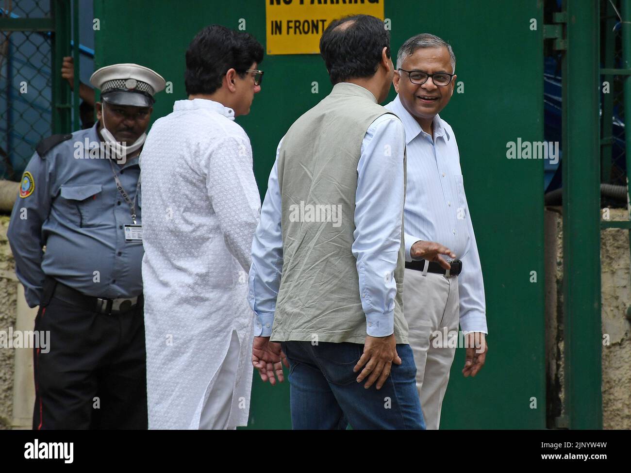 Tata sons chairman Natarajan Chandrasekaran (R) is seen standing ...