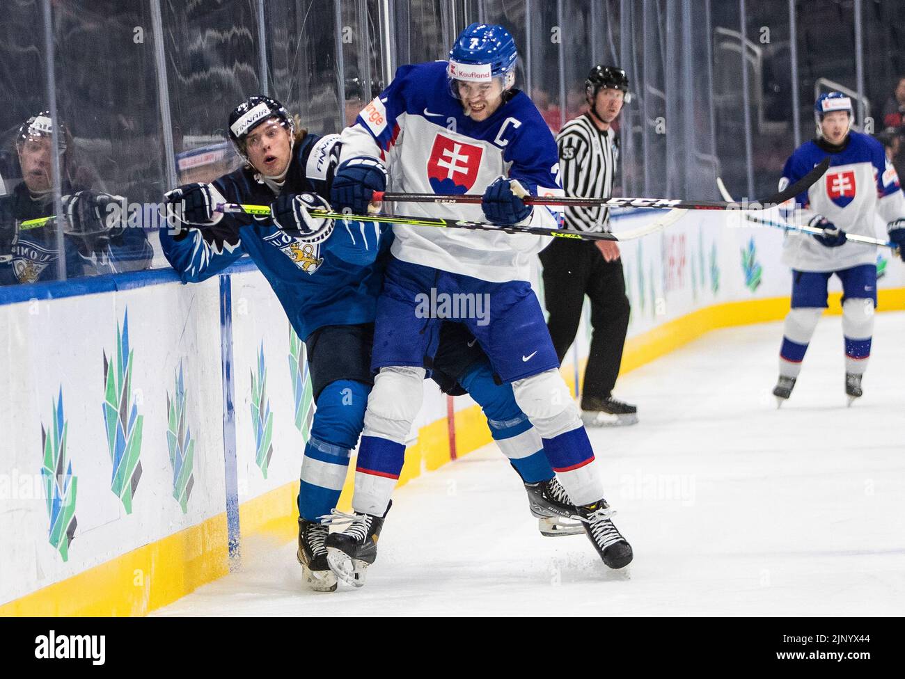 Finland's Ville Koivunen (24) is checked by Slovakia's Rayen Petrovicky ...