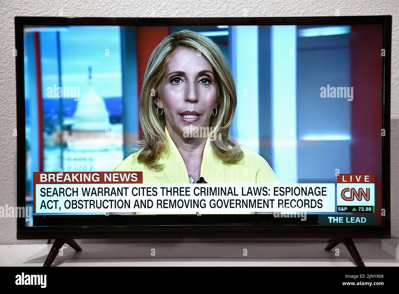 A TV screenshot of CNN news anchor reporting developments on the FBI ...