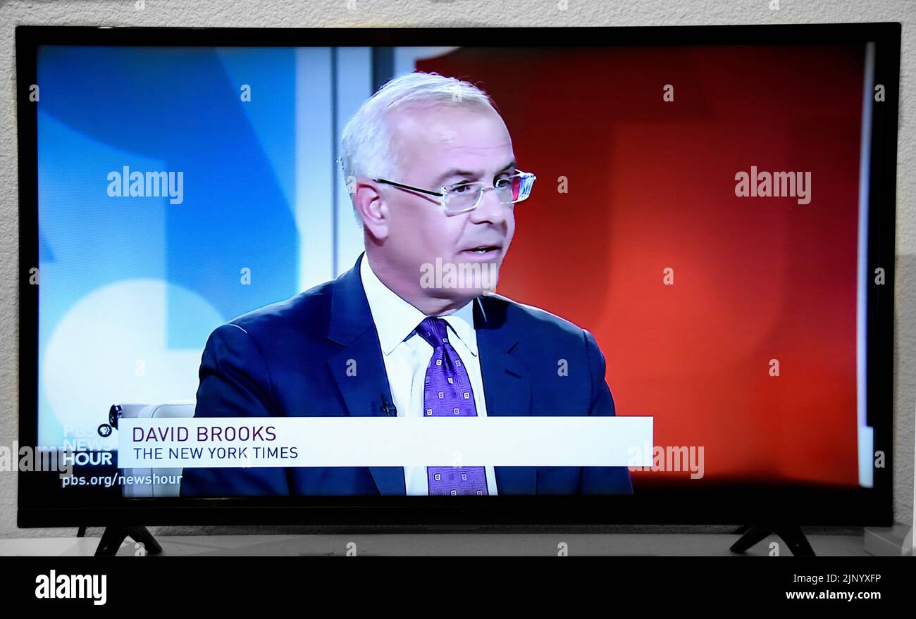 A TV screenshot shows David Brooks, a conservative political ...