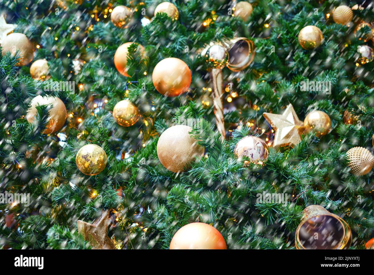 Christmas trees with lots of golden balls, snow bells and yellow ...
