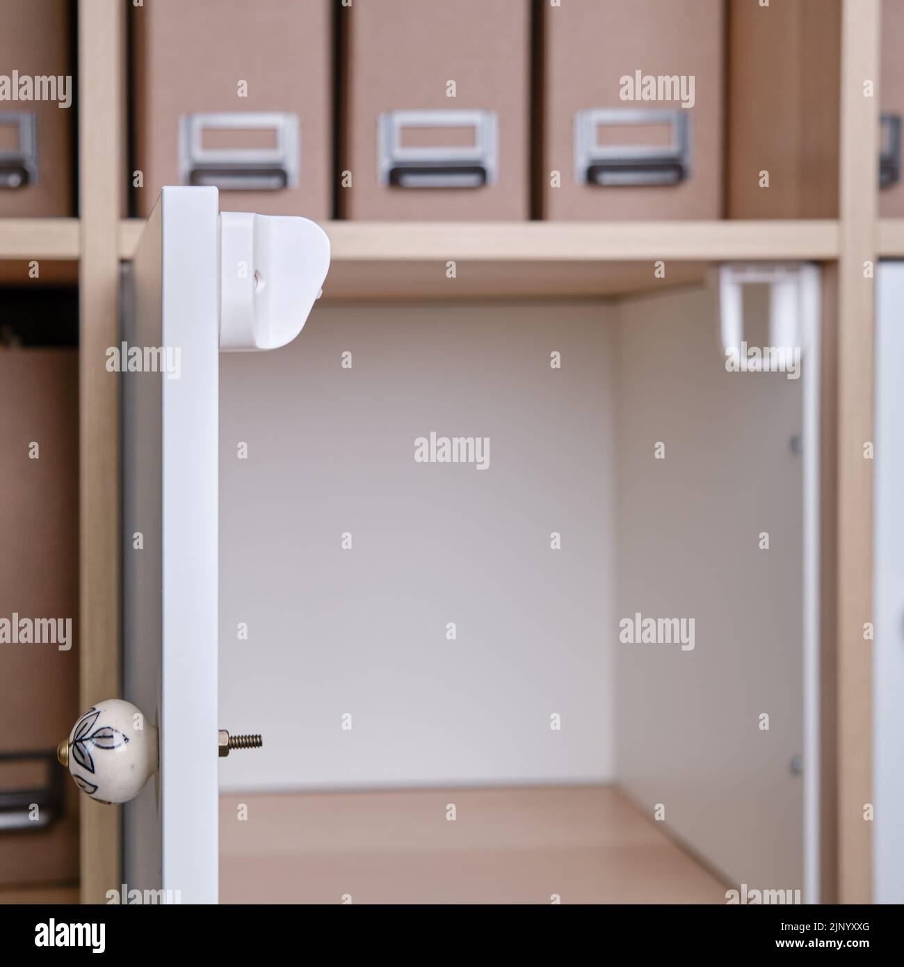 Magnetic child-proof lock for locking cabinet doors and drawers of home furniture Stock Photo ...