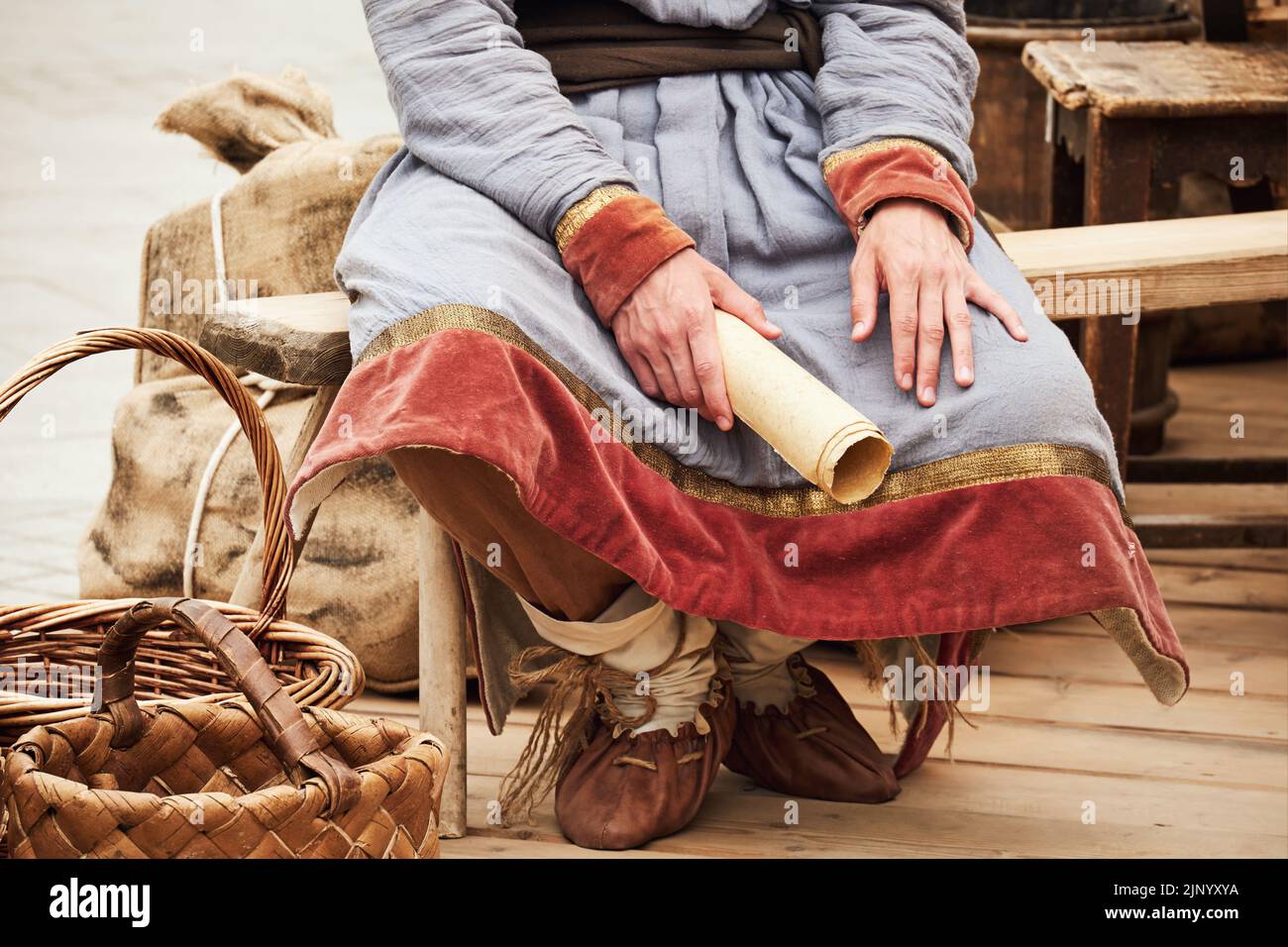 A man in vintage medieval clothes with a paper letter in his hand ...