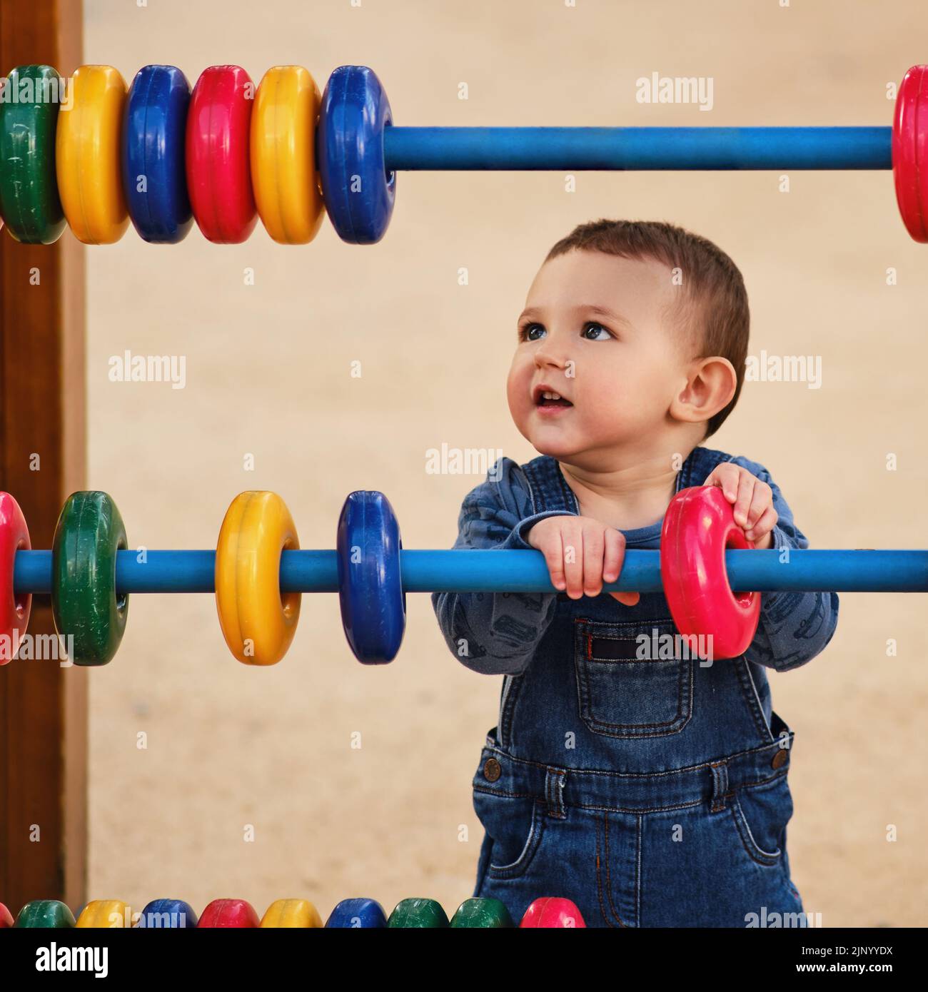 Happy baby learning math on abacus while playing on playground Stock ...