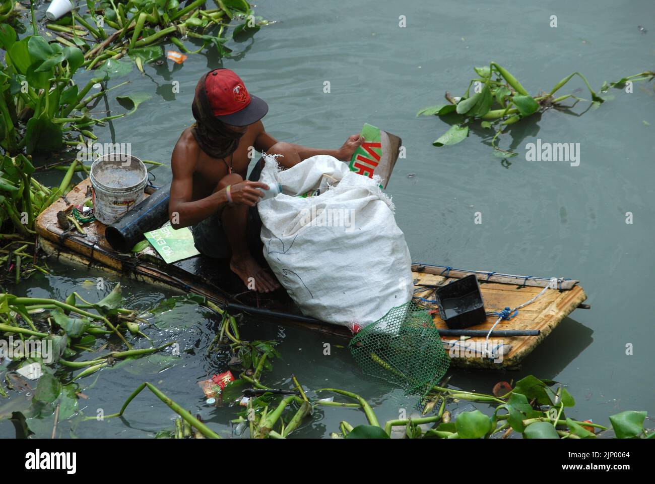 Man collecting bottles on a home made raft, Pasig River, Manila Stock ...