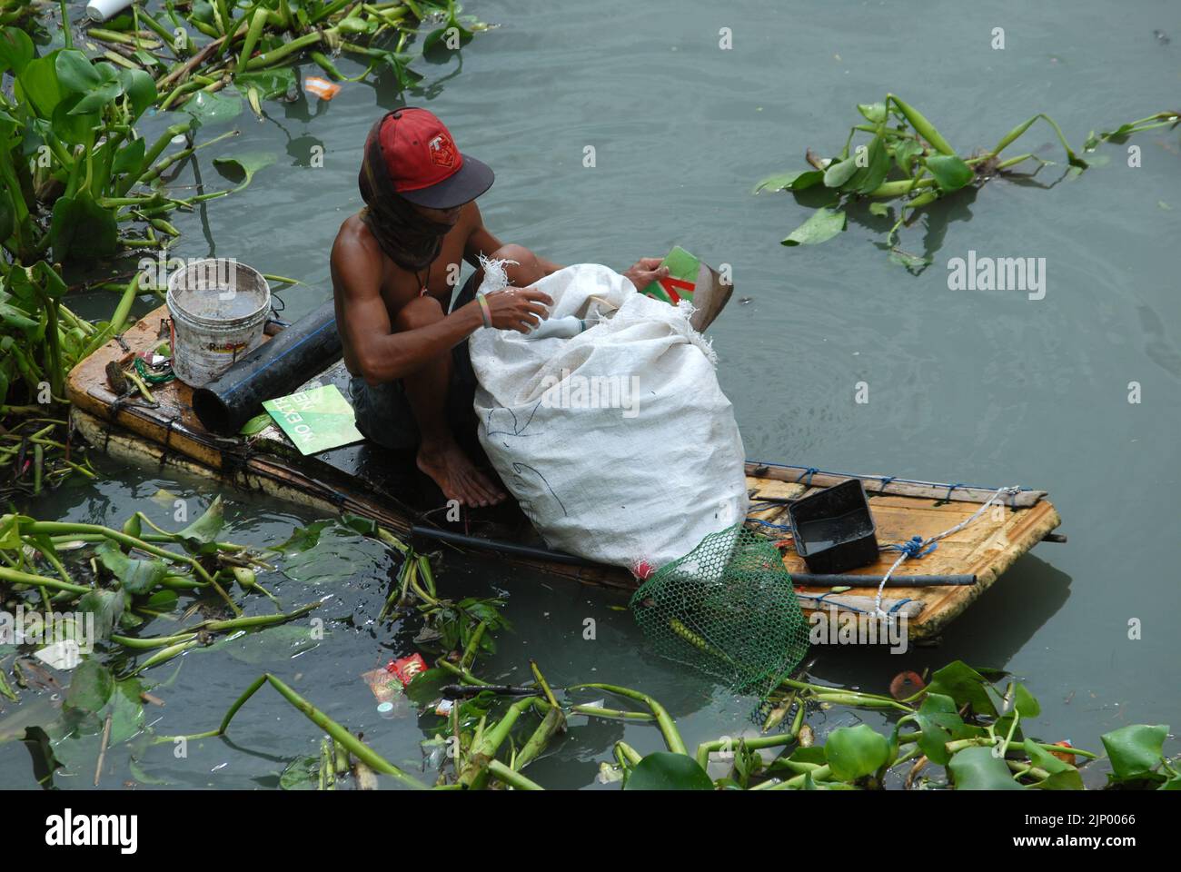 Man collecting bottles on a home made raft, Pasig River, Manila Stock ...