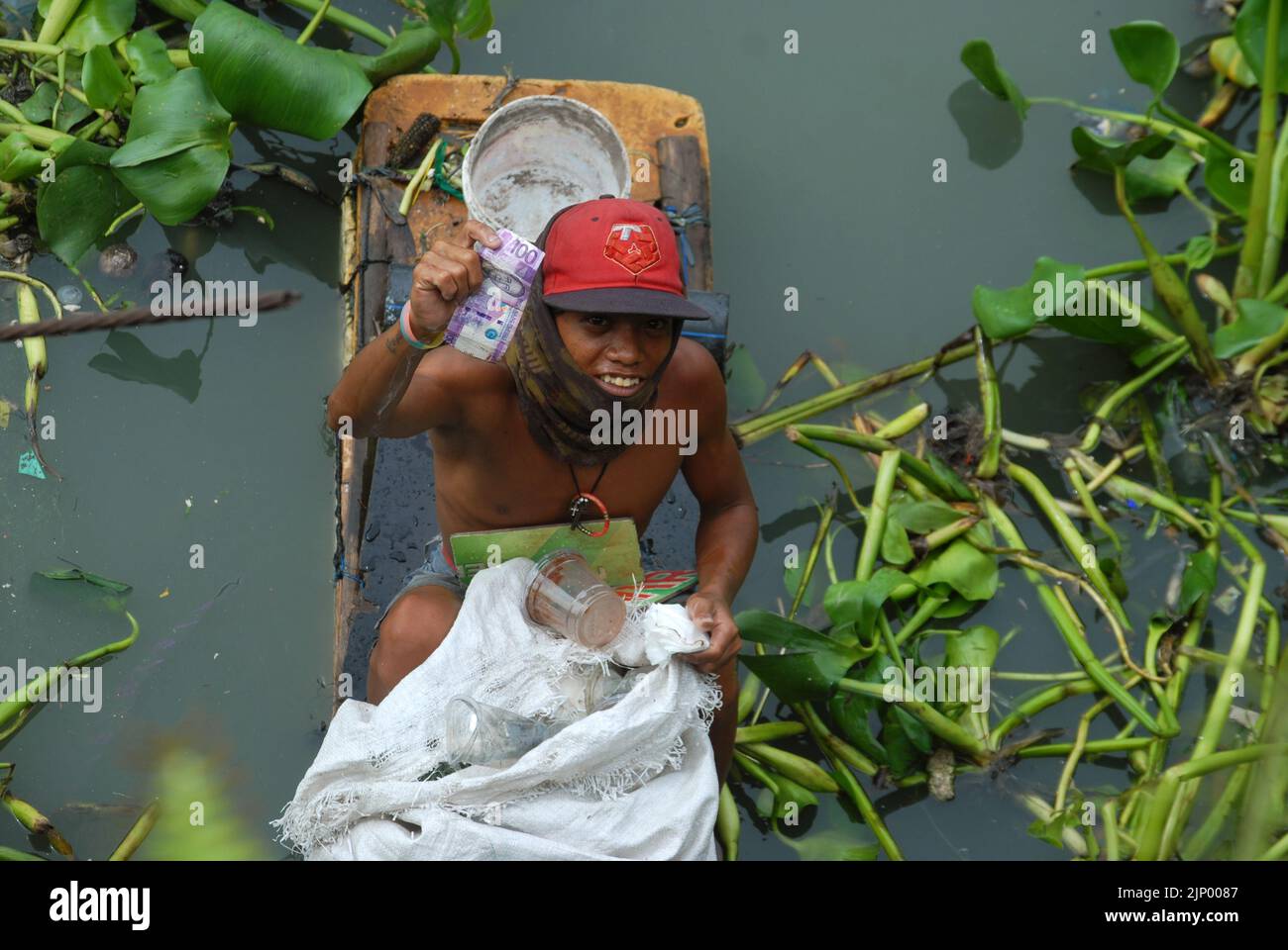 Man collecting bottles on a home made raft, Pasig River, Manila Stock ...