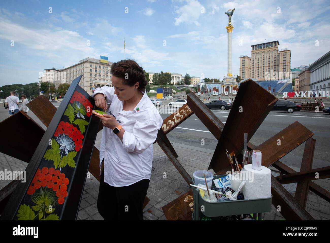 An artist paints anti-tank hedgehog barricades in central Kyiv. (Photo ...