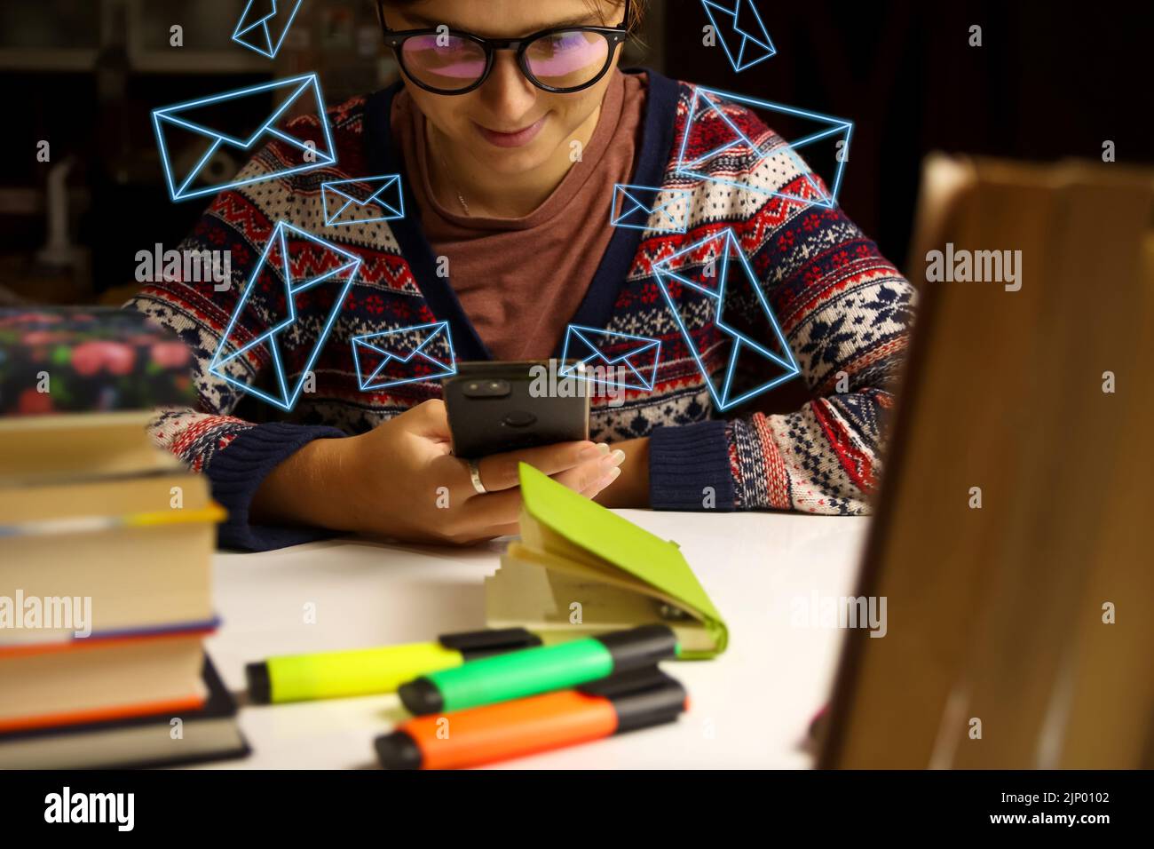 Young happy woman in glasses study at night. Millennial student ...
