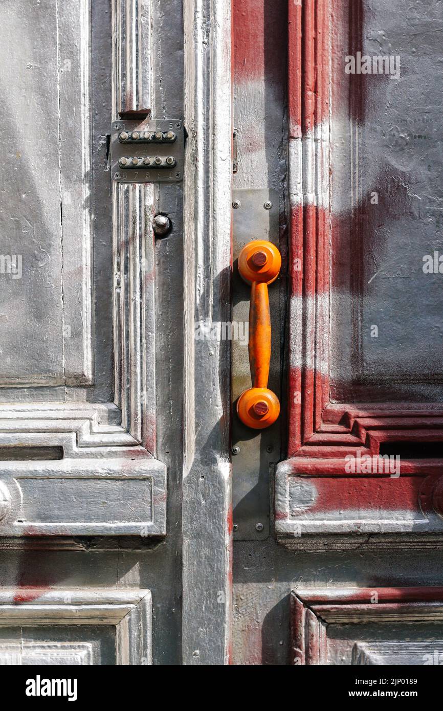 Defocus brown vintage telephone receiver on handle door. Closed wooden ...