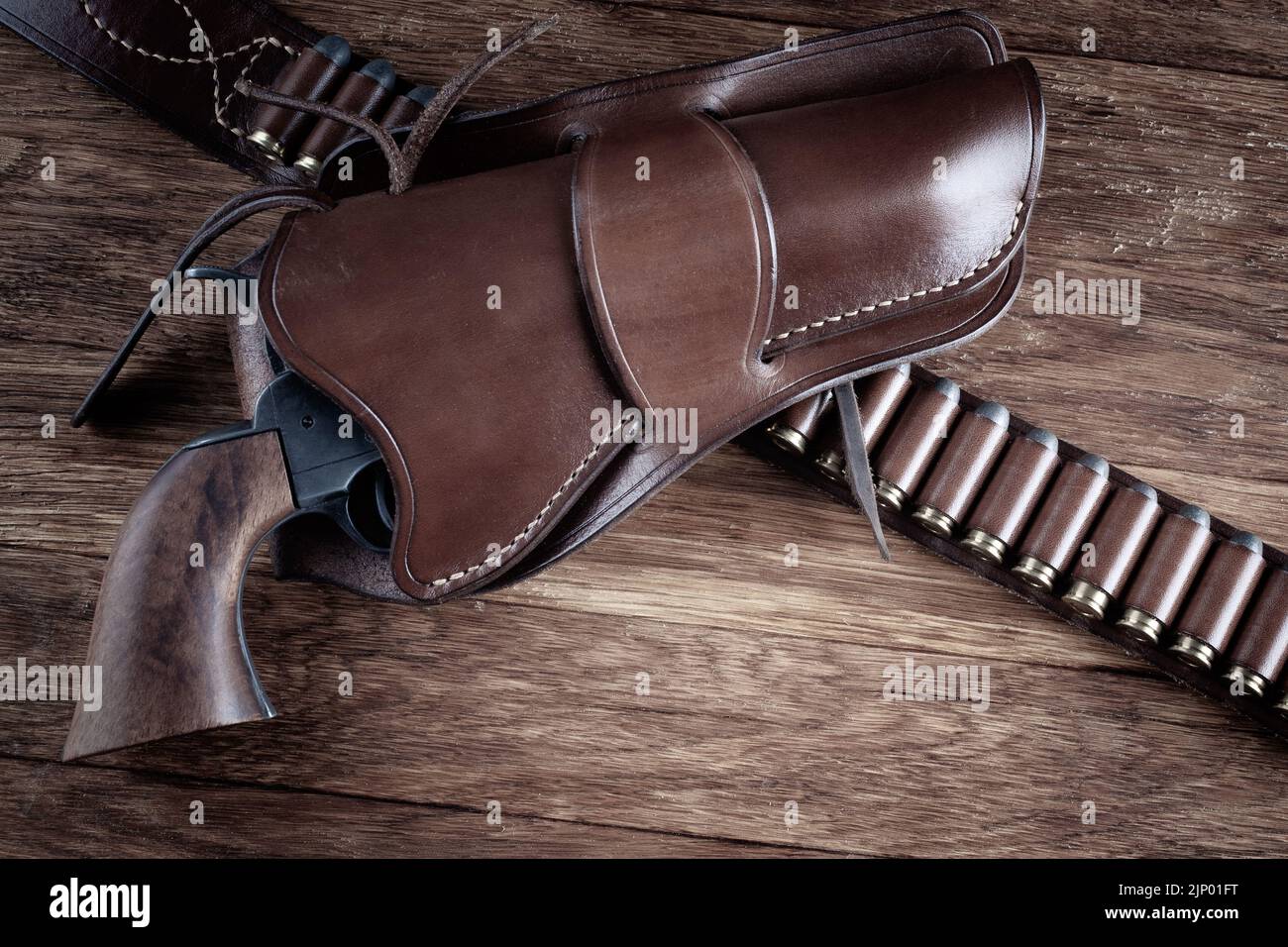 Old west weapon - Colt Revolver and gunbelt with holster on wooden deck ...