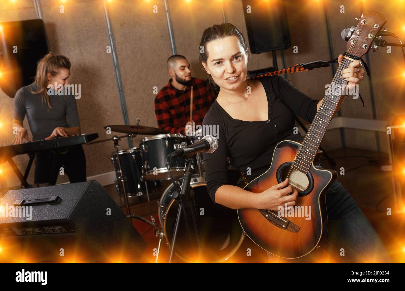 excited girl rock singer with guitar during rehearsal Stock Photo - Alamy