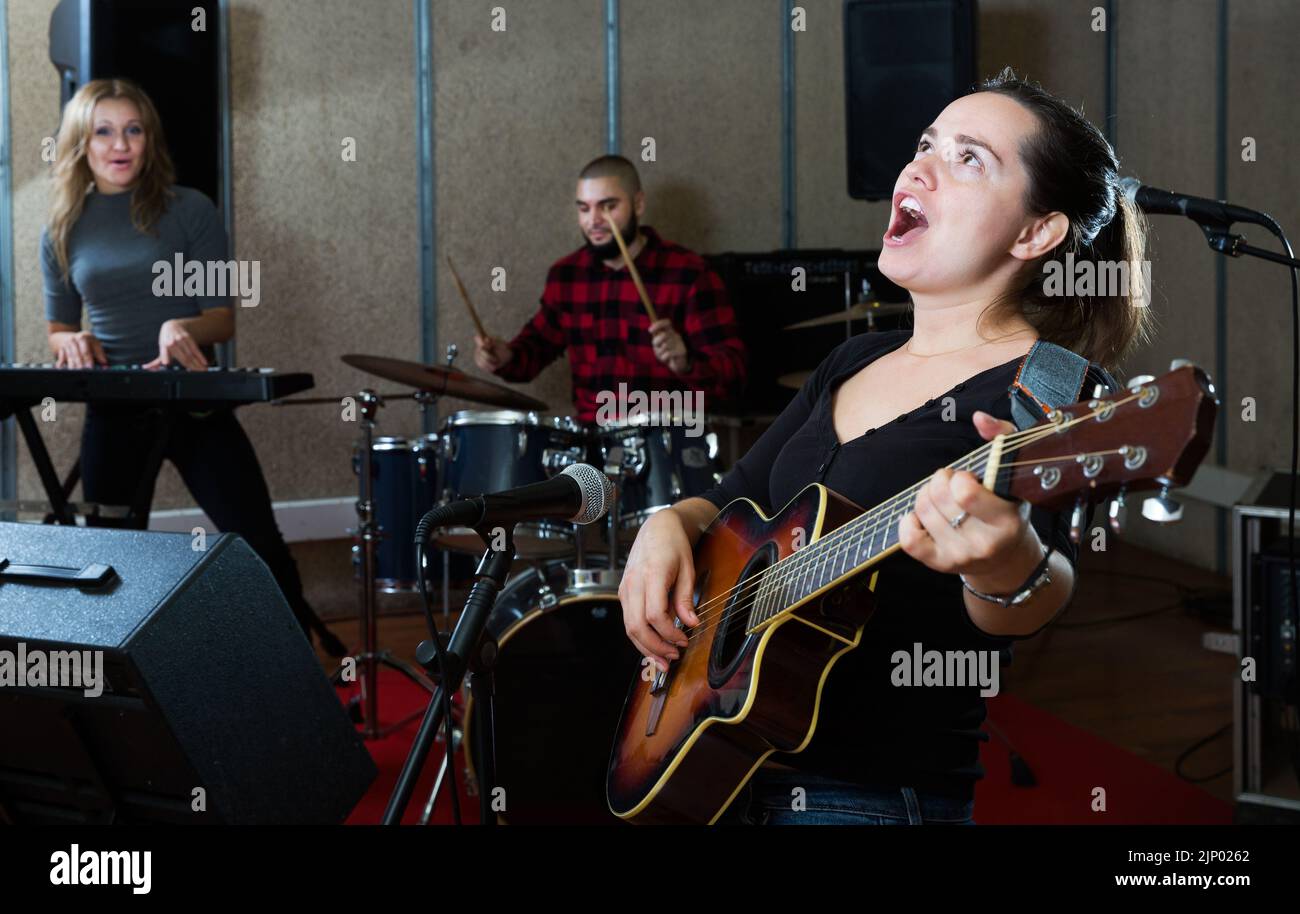 excited girl rock singer with guitar during rehearsal Stock Photo - Alamy