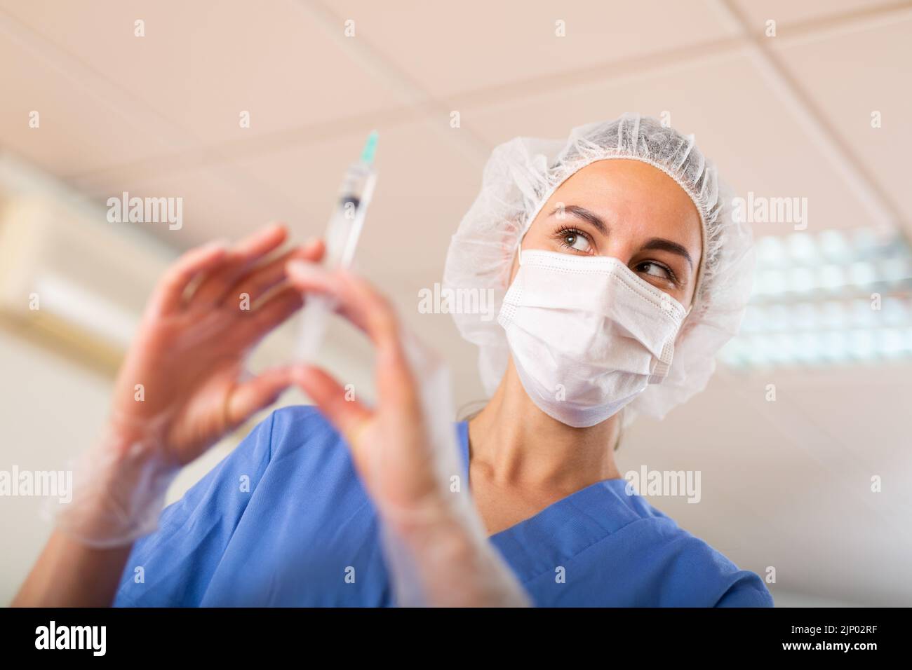 Nurse prepares a syringe for injection Stock Photo - Alamy