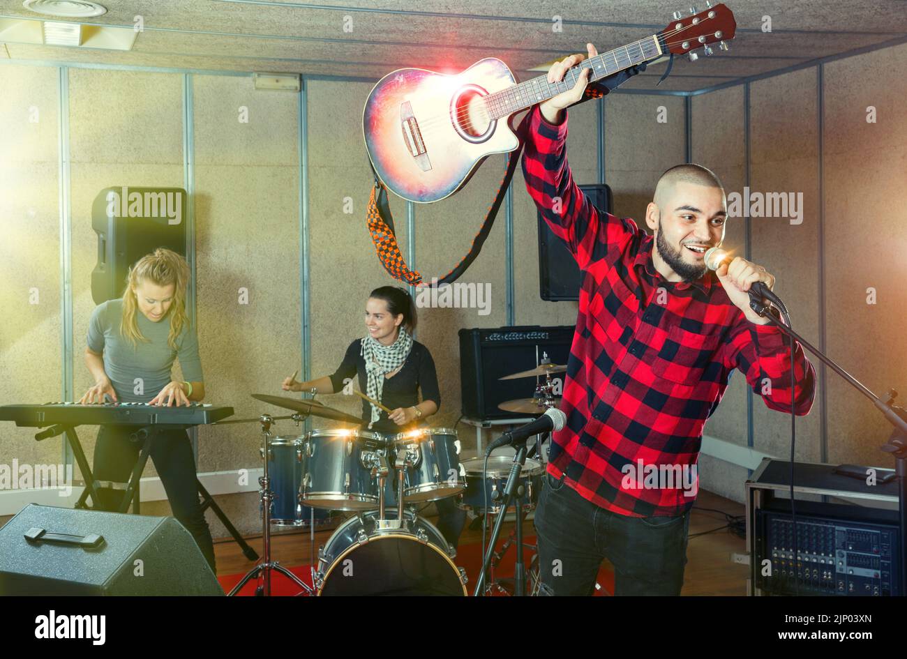 Guy guitar player and singer practicing with band members in re Stock ...