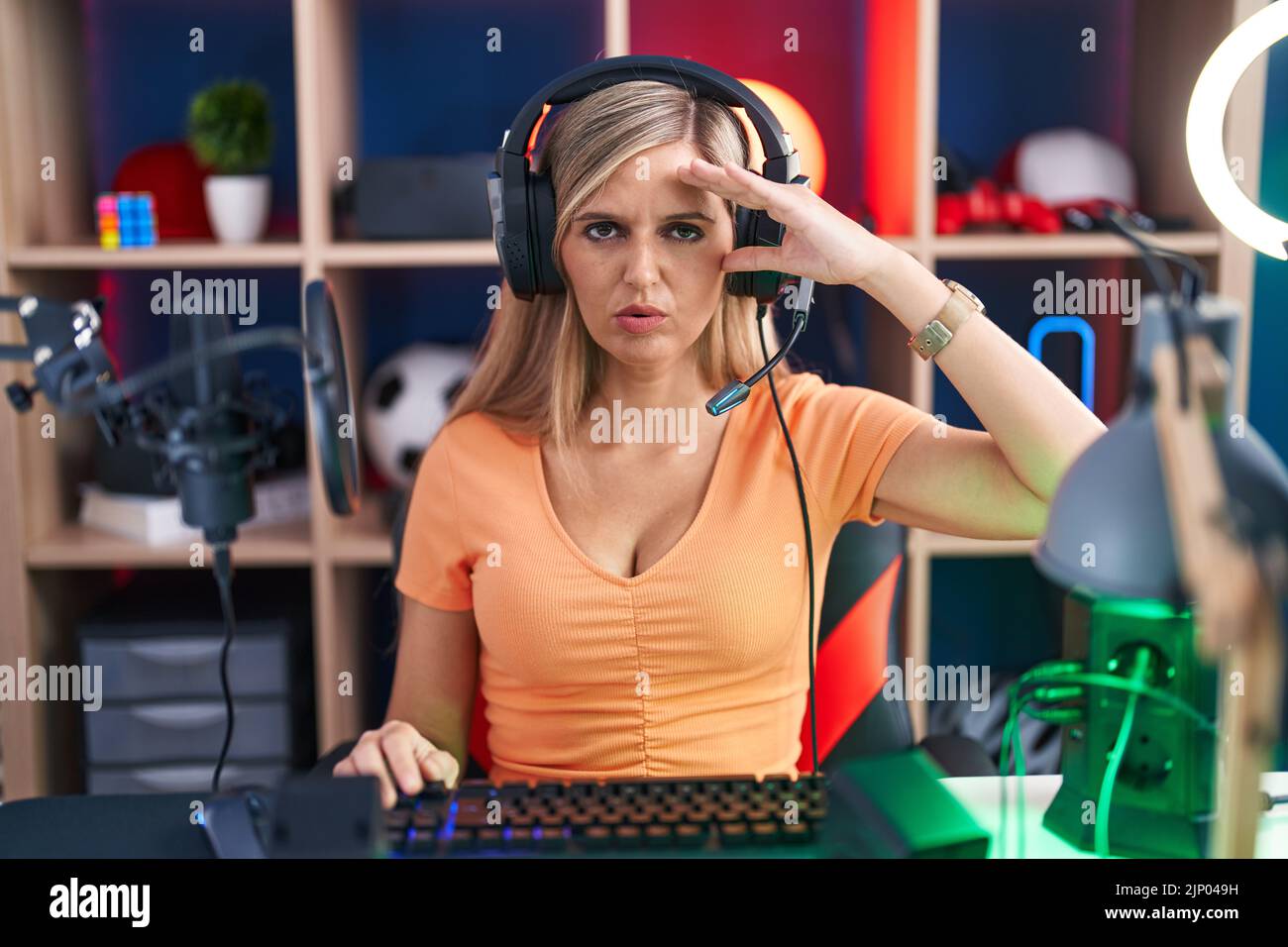 Young woman playing video games worried and stressed about a problem ...