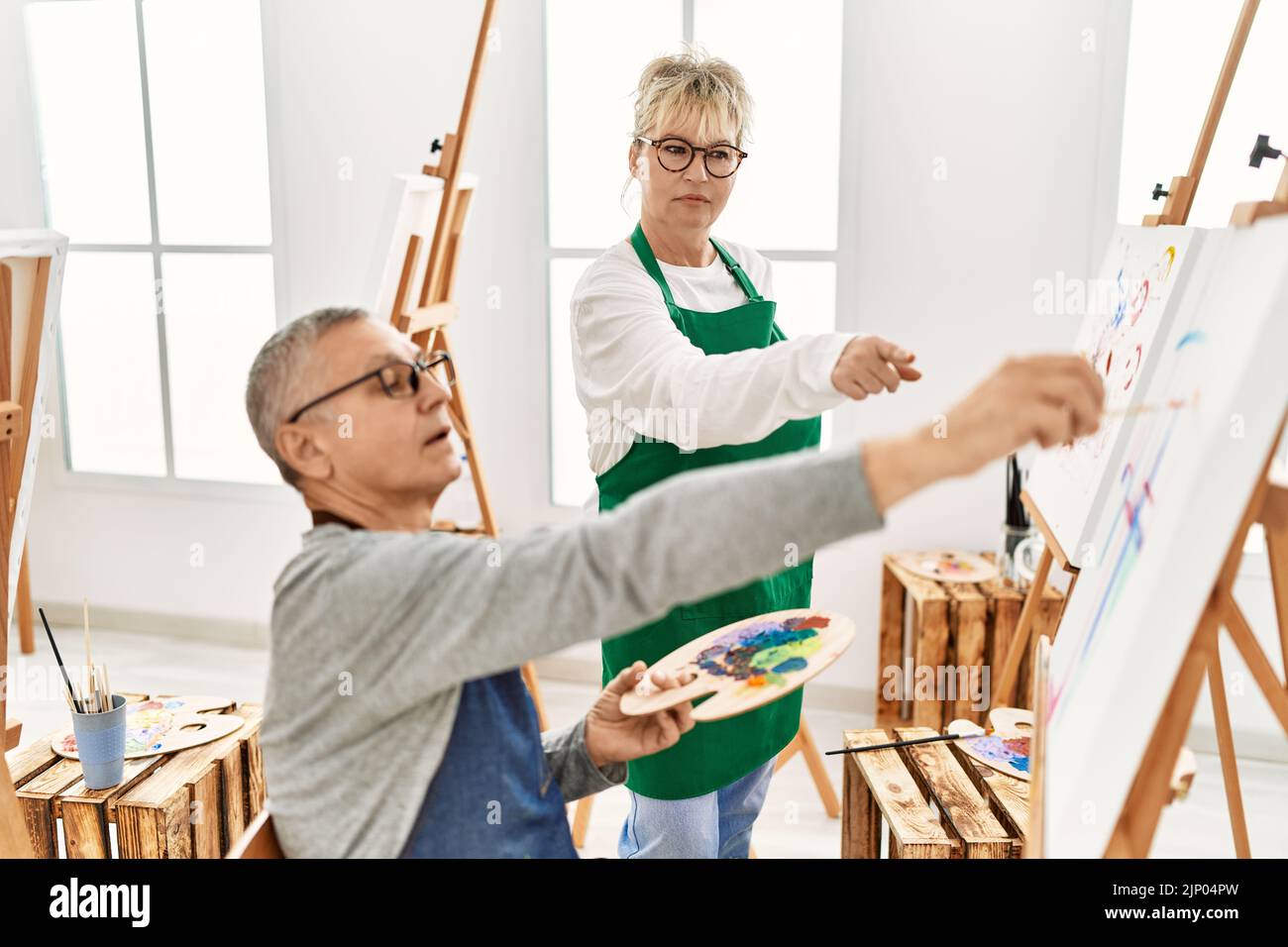 Paint teacher and student painting at art studio Stock Photo - Alamy