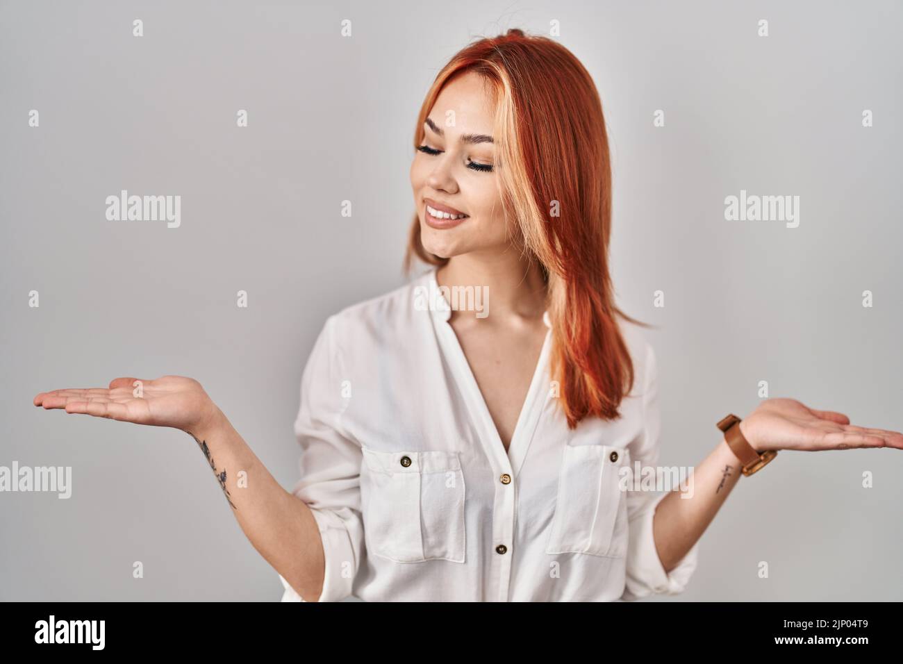 Young caucasian woman standing over isolated background smiling showing ...