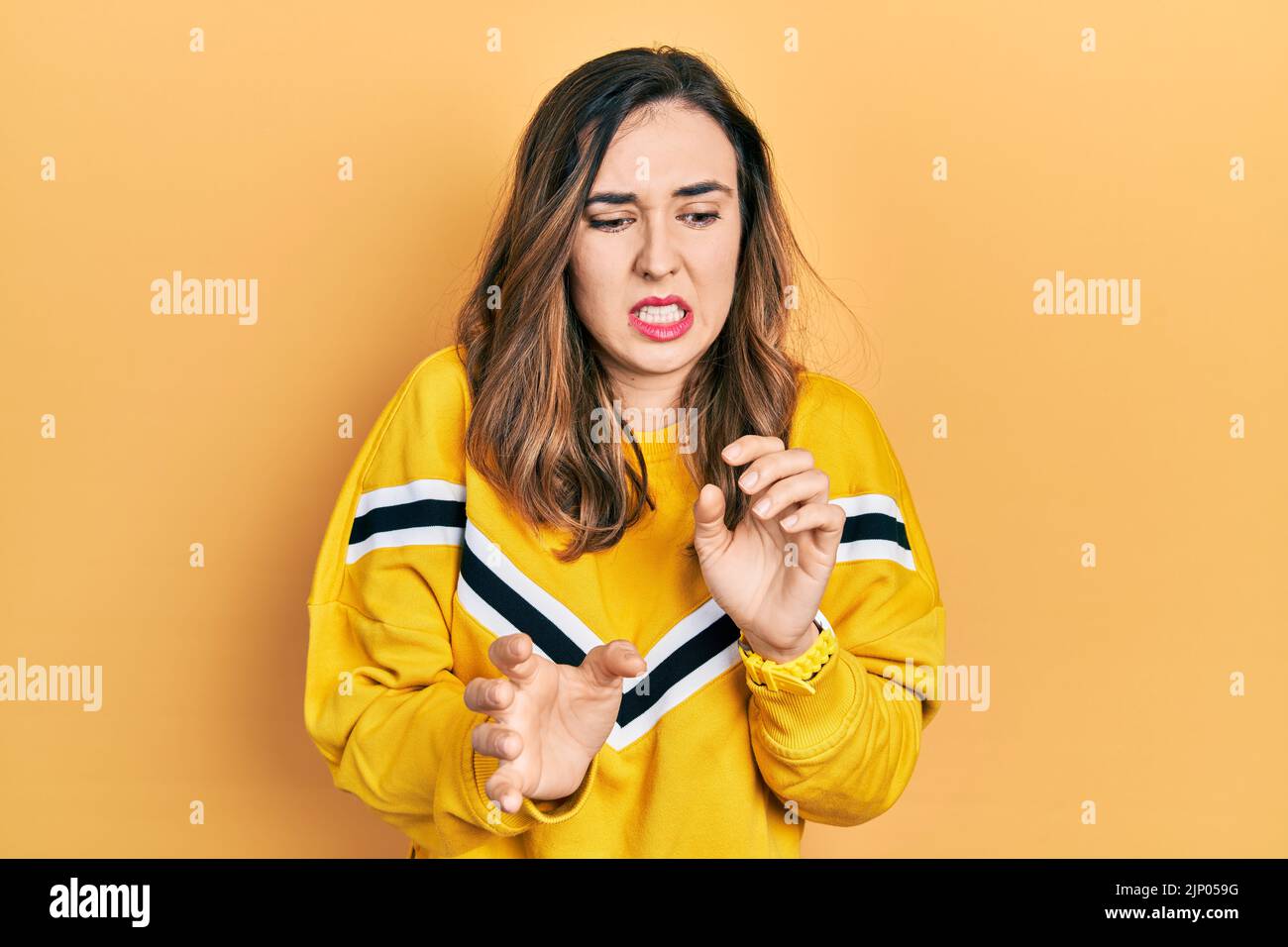 Young hispanic girl wearing casual clothes disgusted expression ...