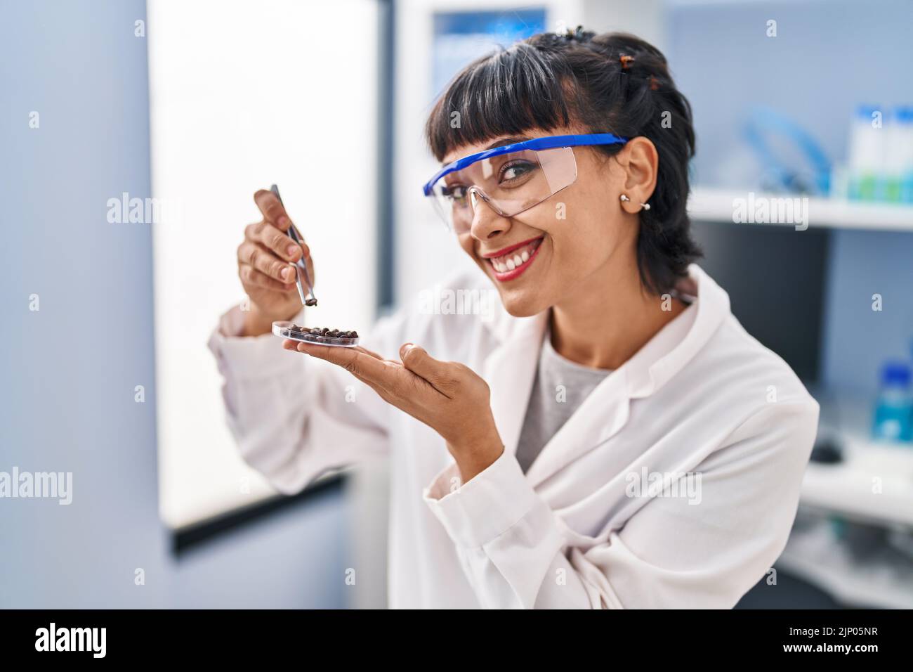 Young woman scientist holding sample at laboratory Stock Photo - Alamy