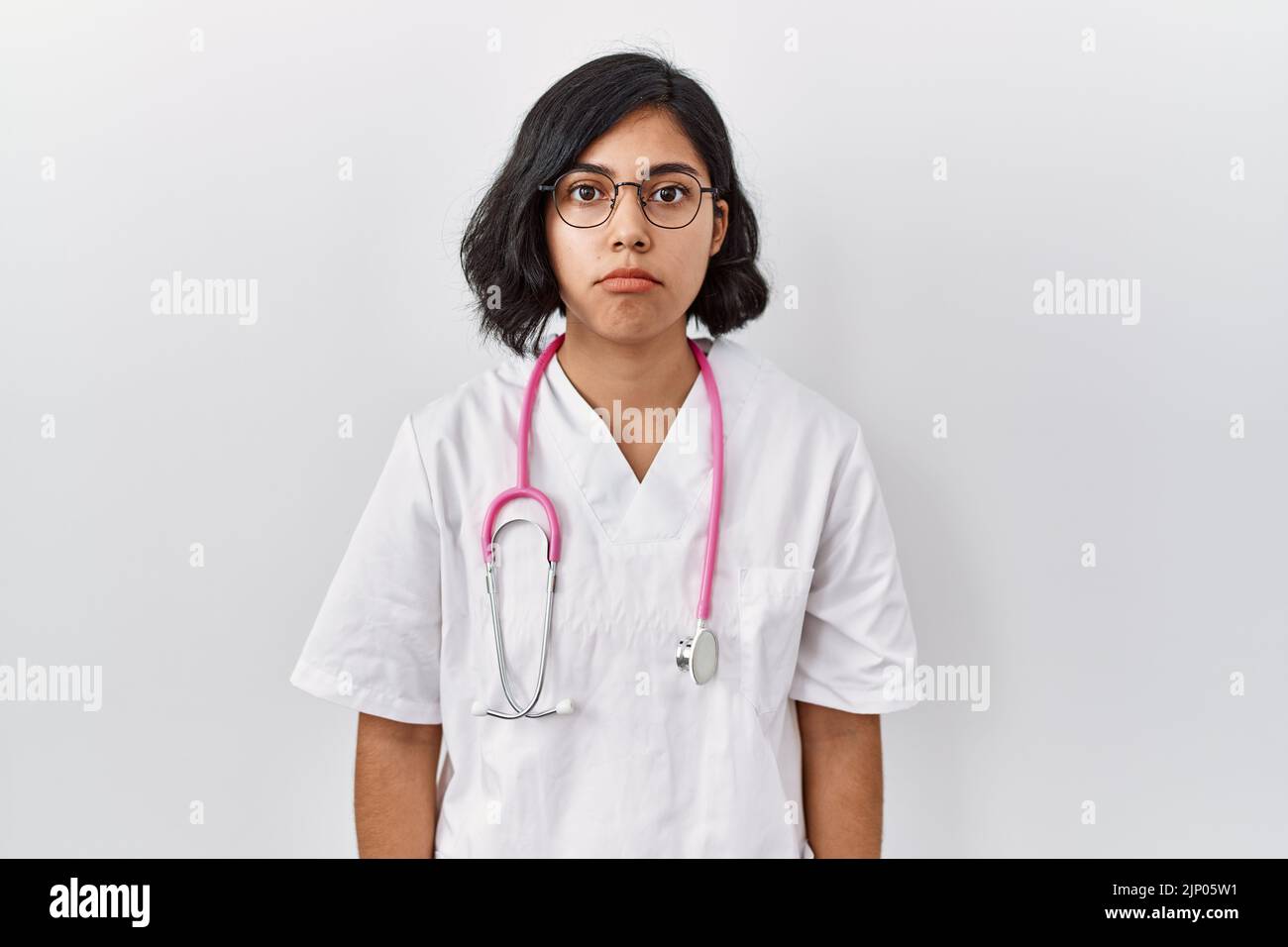 Young hispanic doctor woman wearing stethoscope over isolated ...