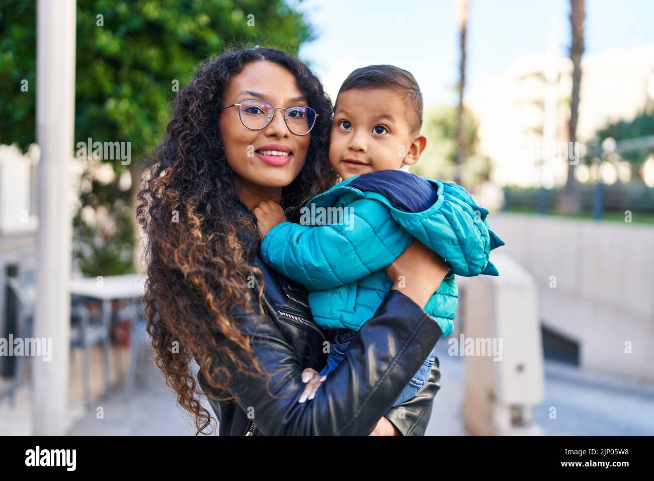 Mother and son hugging each other standing at street Stock Photo - Alamy