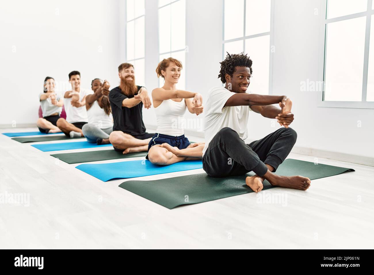 Group of young people smiling happy stretching at sport center Stock ...