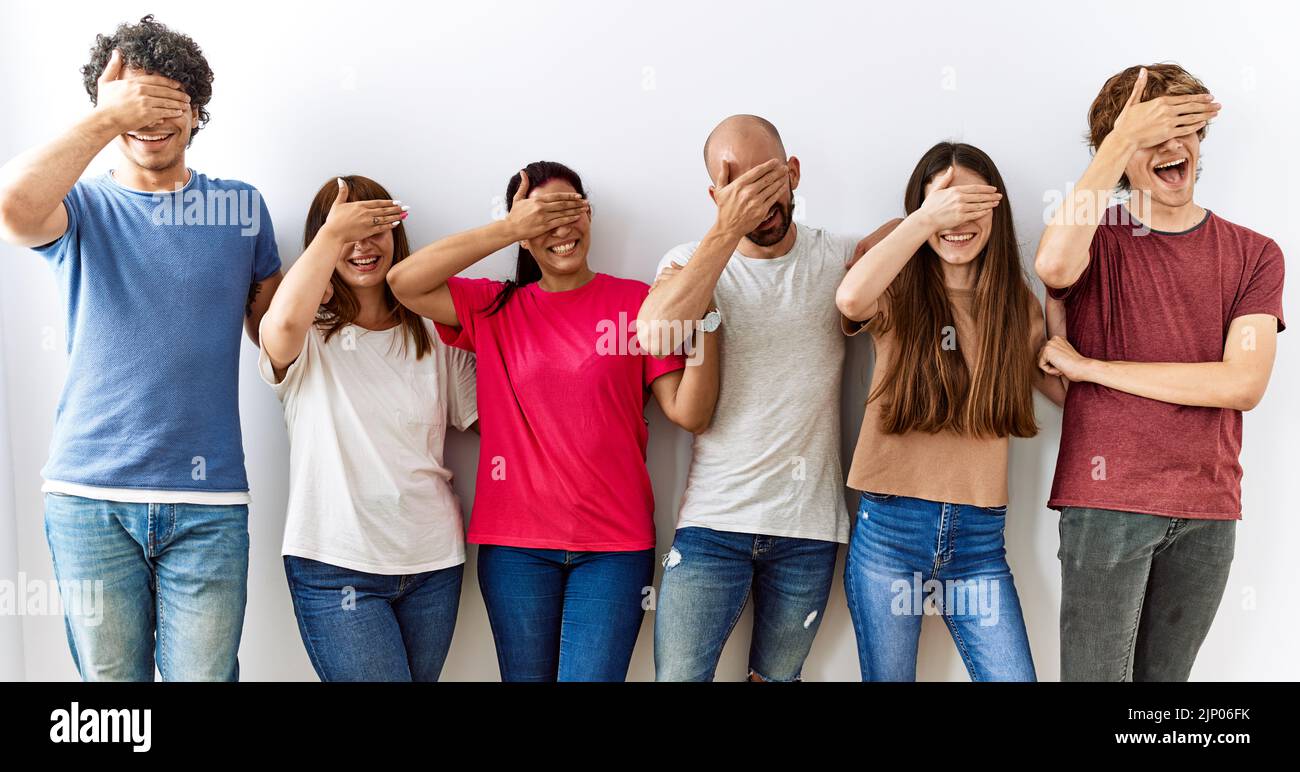 Group of young friends standing together over isolated background ...