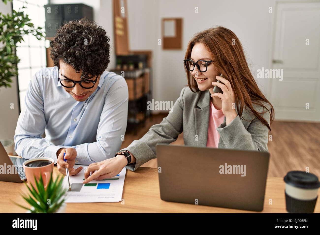 Two business workers smiling happy working and talking on the ...