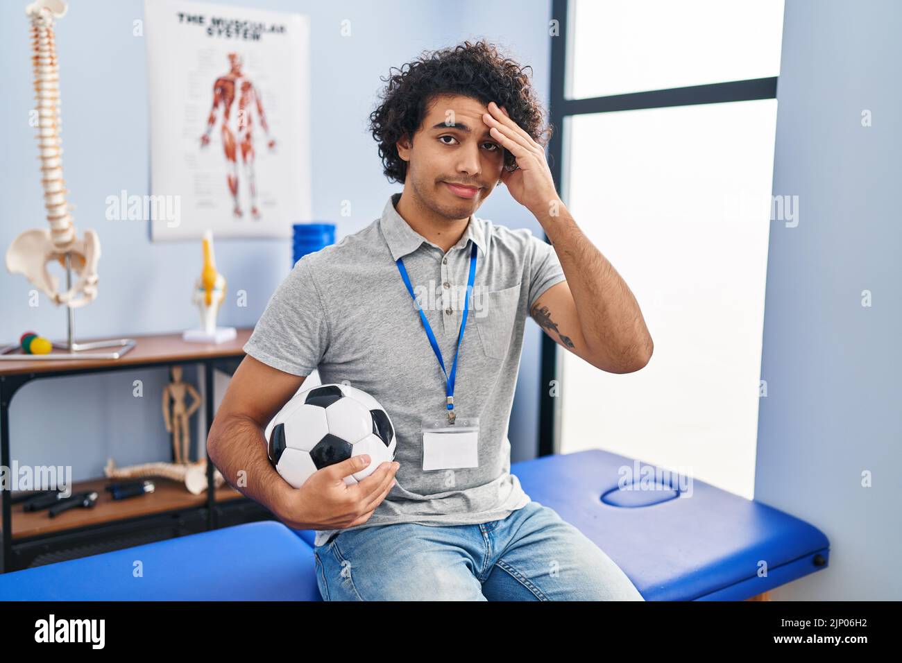 Hispanic man with curly hair working as football physiotherapist ...
