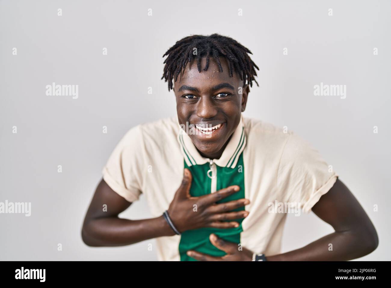 African man with dreadlocks standing over isolated background smiling ...