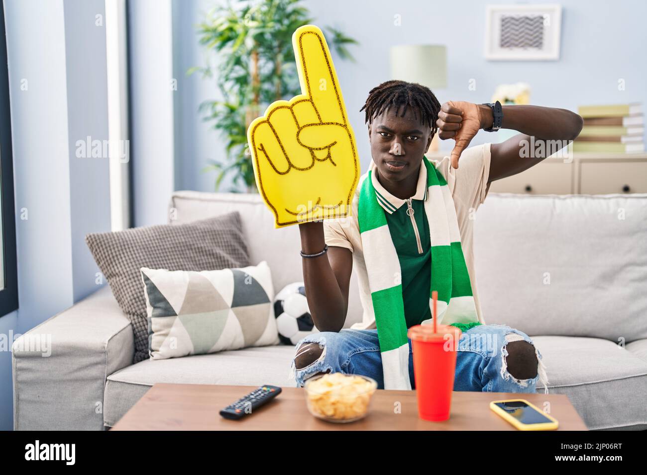 African man with dreadlocks football hooligan supporting team with ...
