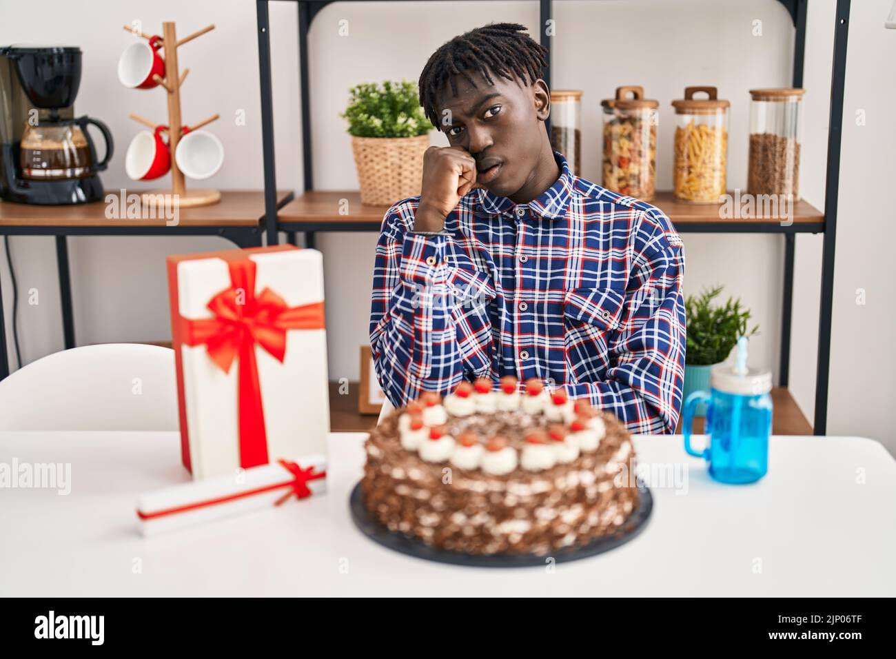 African man with dreadlocks celebrating birthday holding big chocolate ...