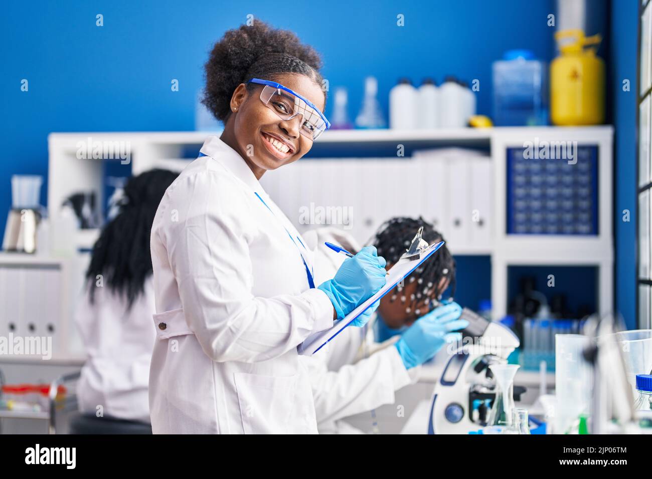 African american friends scientists writing on clipboard working at ...