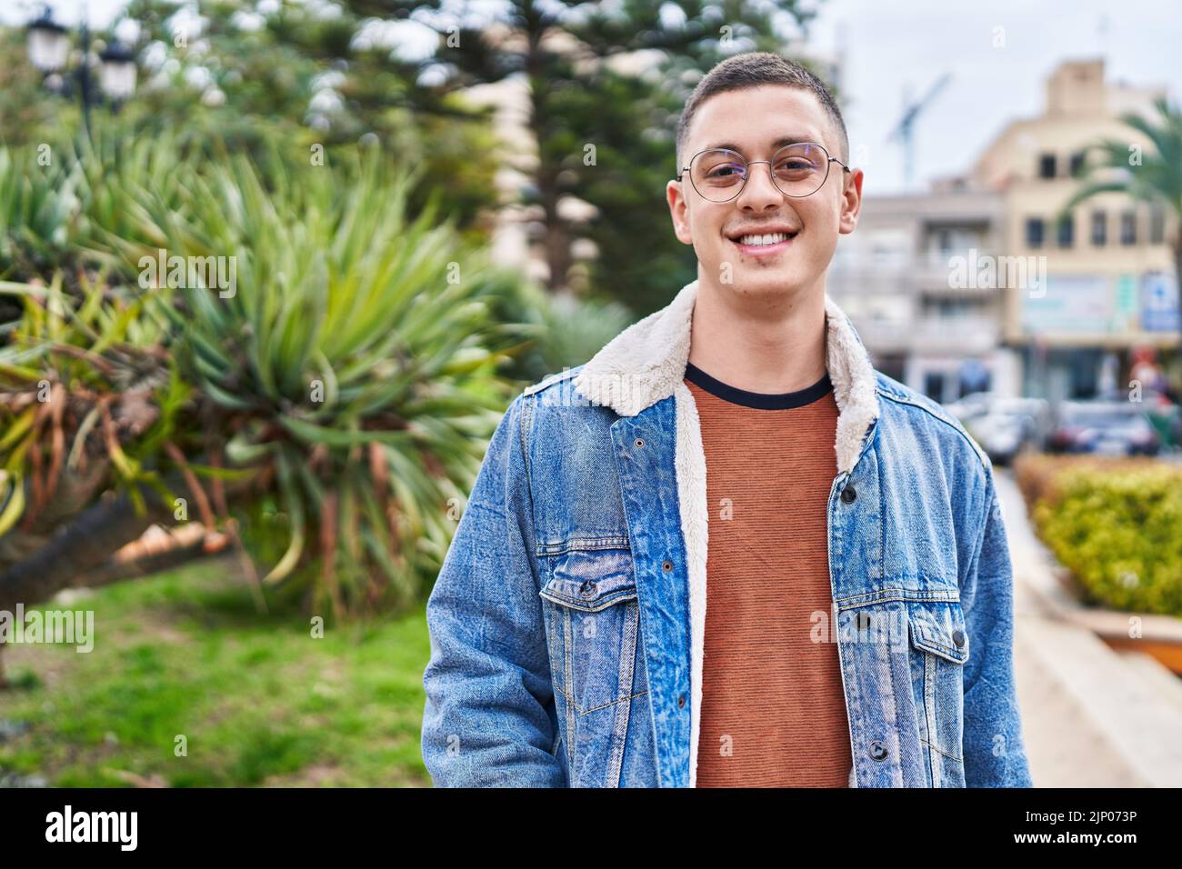 Young hispanic man smiling confident standing at park Stock Photo - Alamy