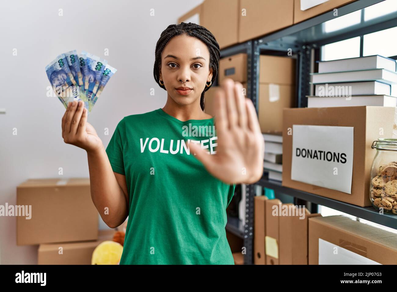 Young african american woman wearing volunteer t shirt holding african ...