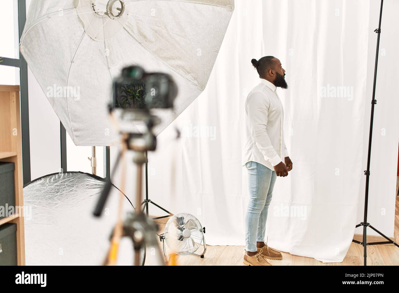 African american man posing as model at photography studio looking to ...