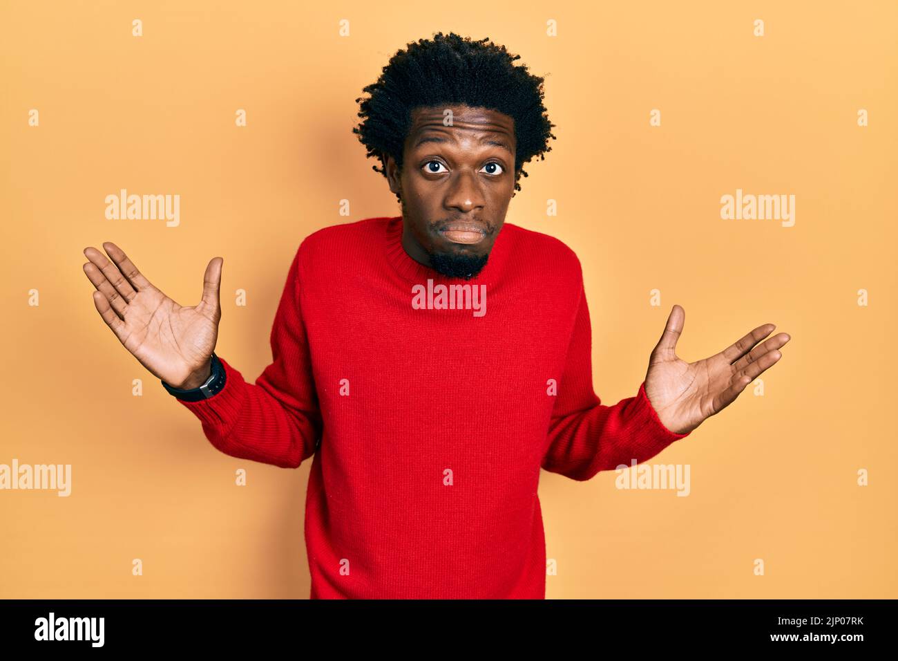 Young african american man wearing casual clothes clueless and confused ...