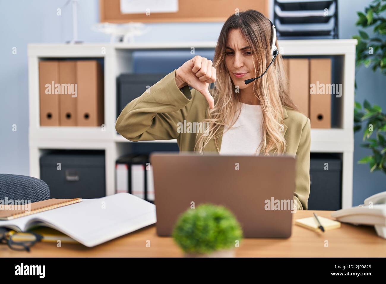 Young hispanic woman wearing call center agent headset working at the ...